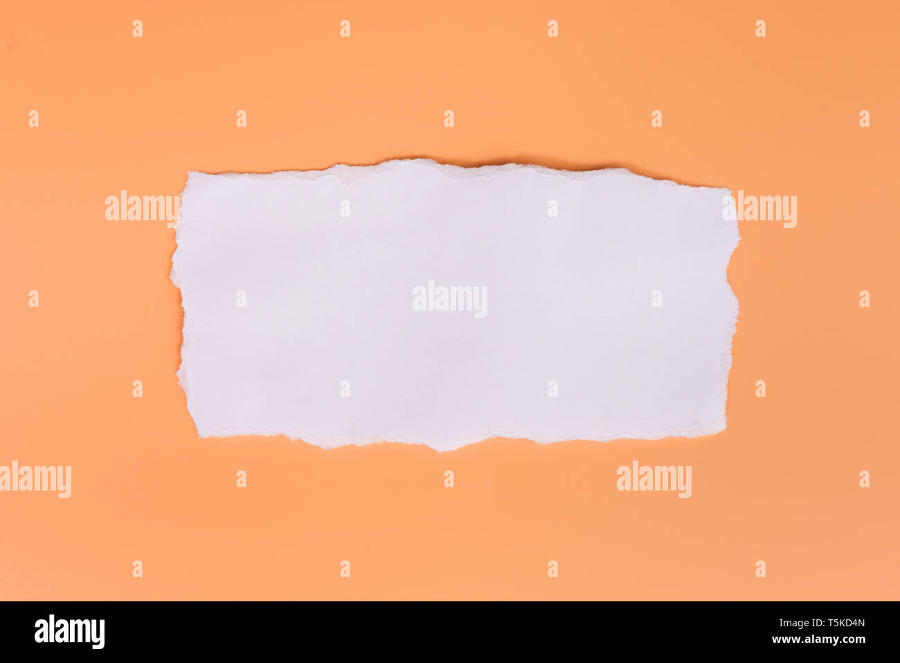 A piece of white torned paper over orange background Stock Photo - Alamy