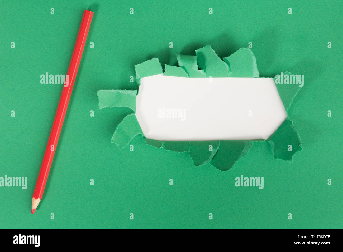 Green torned paper over white background with pencil Stock Photo - Alamy