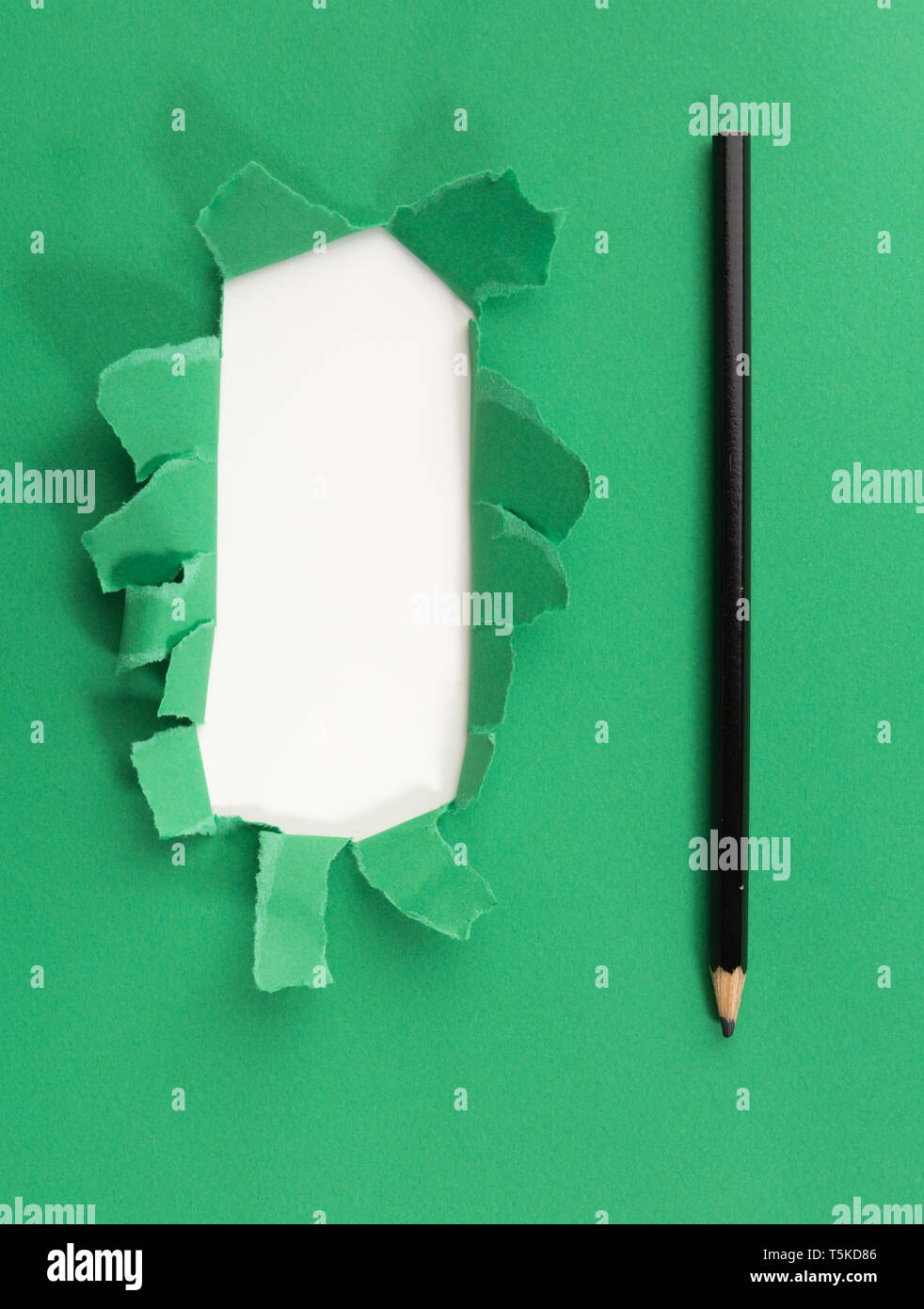 Green torned paper over white background with pencil Stock Photo - Alamy