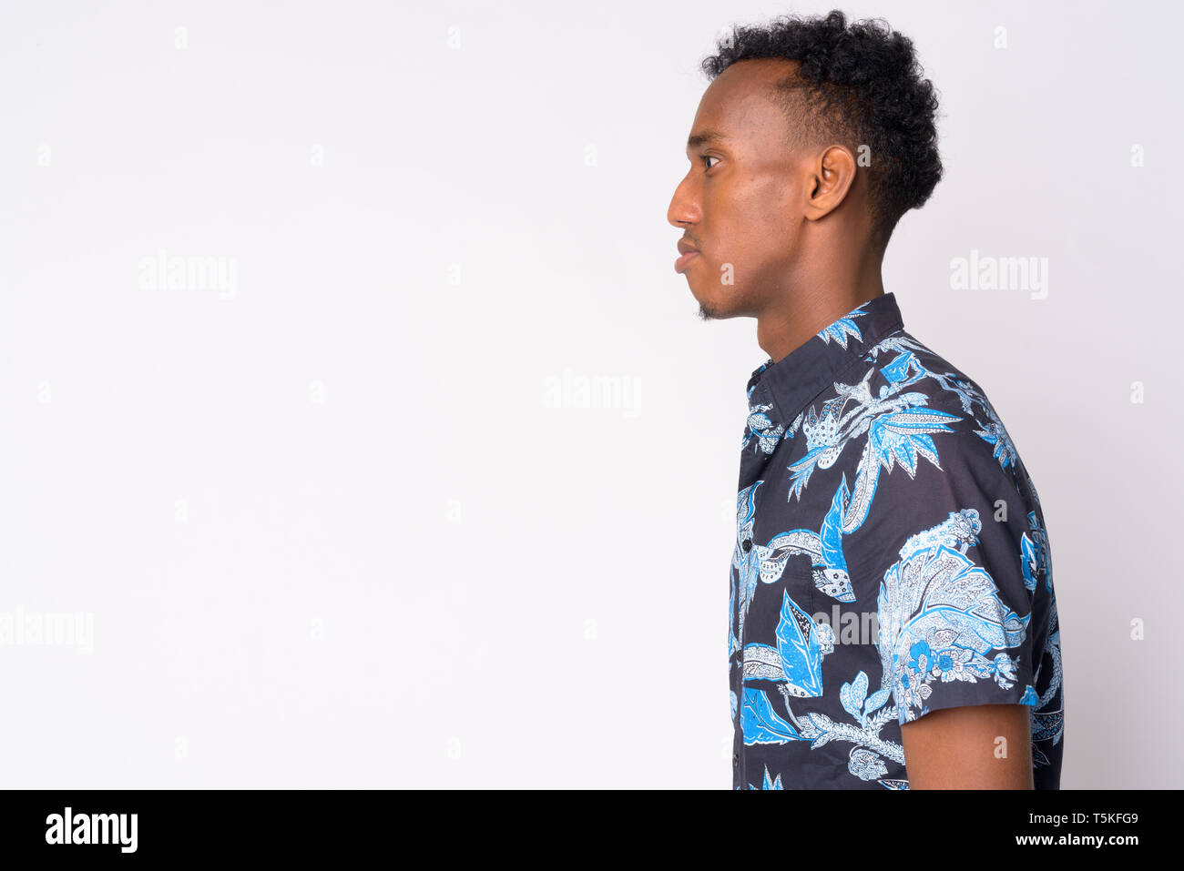 Profile view of young handsome African tourist man Stock Photo - Alamy