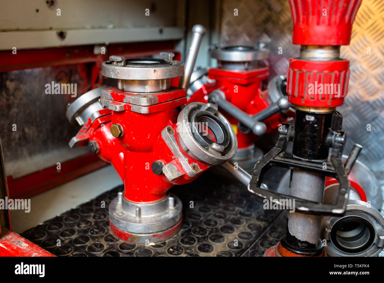 Fire hose collector with three outlets, in red color with a large ...