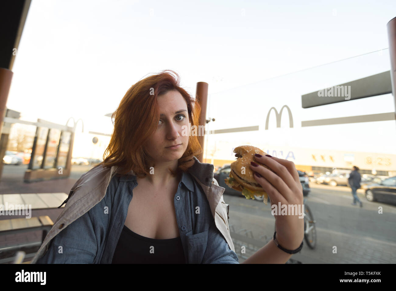 RIGA, LATVIA - APRIL 22, 2019: Hamburger close up - Young Woman eating ...