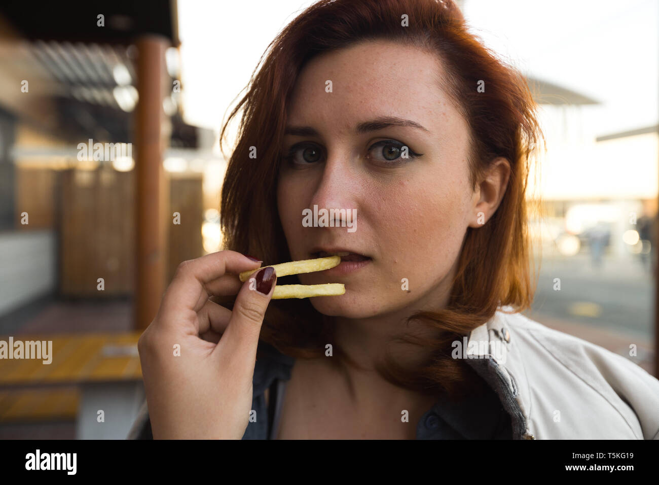 Fri potatoes close up face - Eating and enjoying - Young Woman eating ...