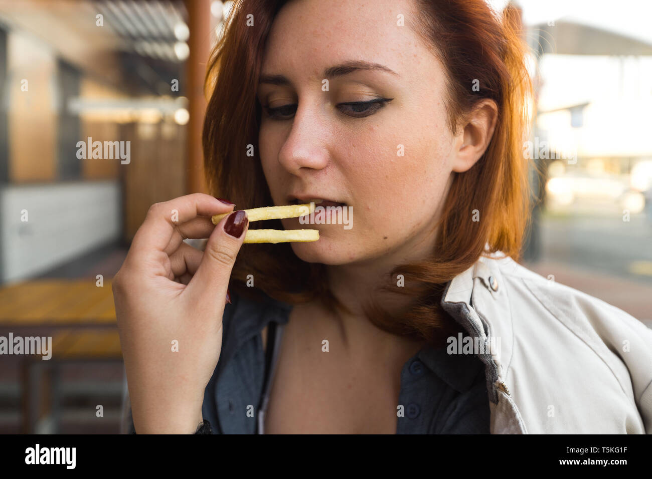 Fri potatoes close up face - Eating and enjoying - Young Woman eating ...