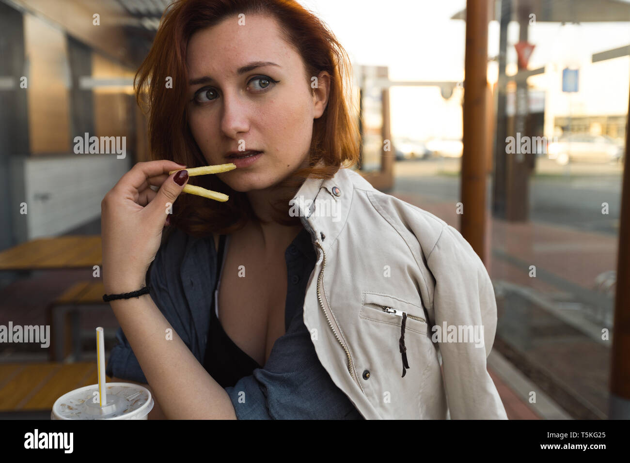 Fri potatoes close up face - Eating and enjoying - Young Woman eating ...