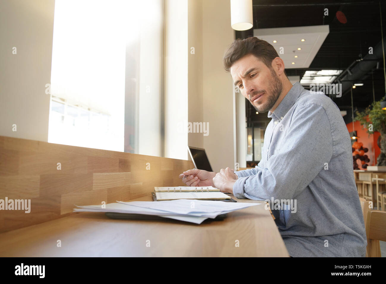 Handsome salesman preparing presentation on work trip Stock Photo - Alamy