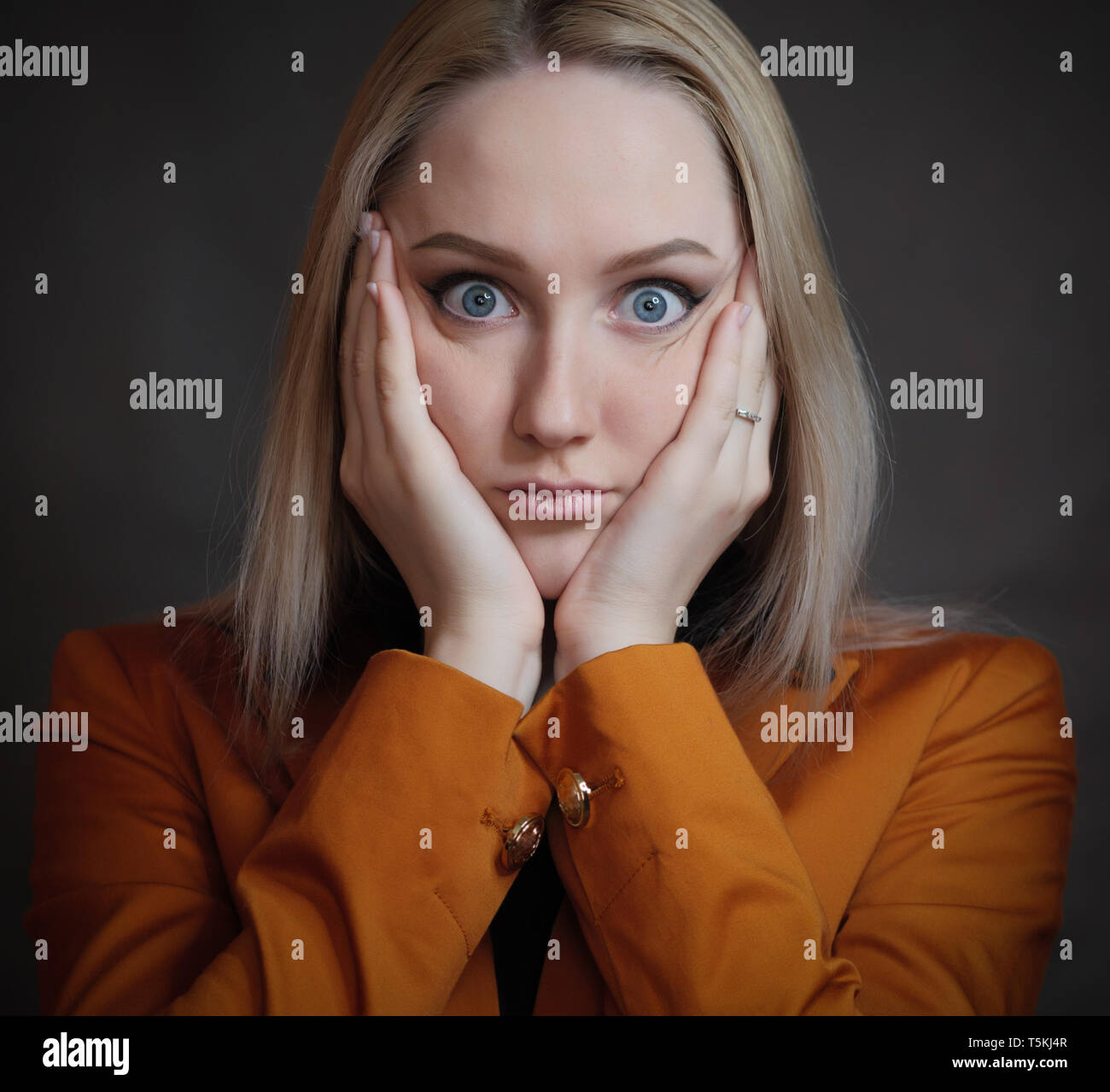 Surprised face. Dark background Stock Photo - Alamy