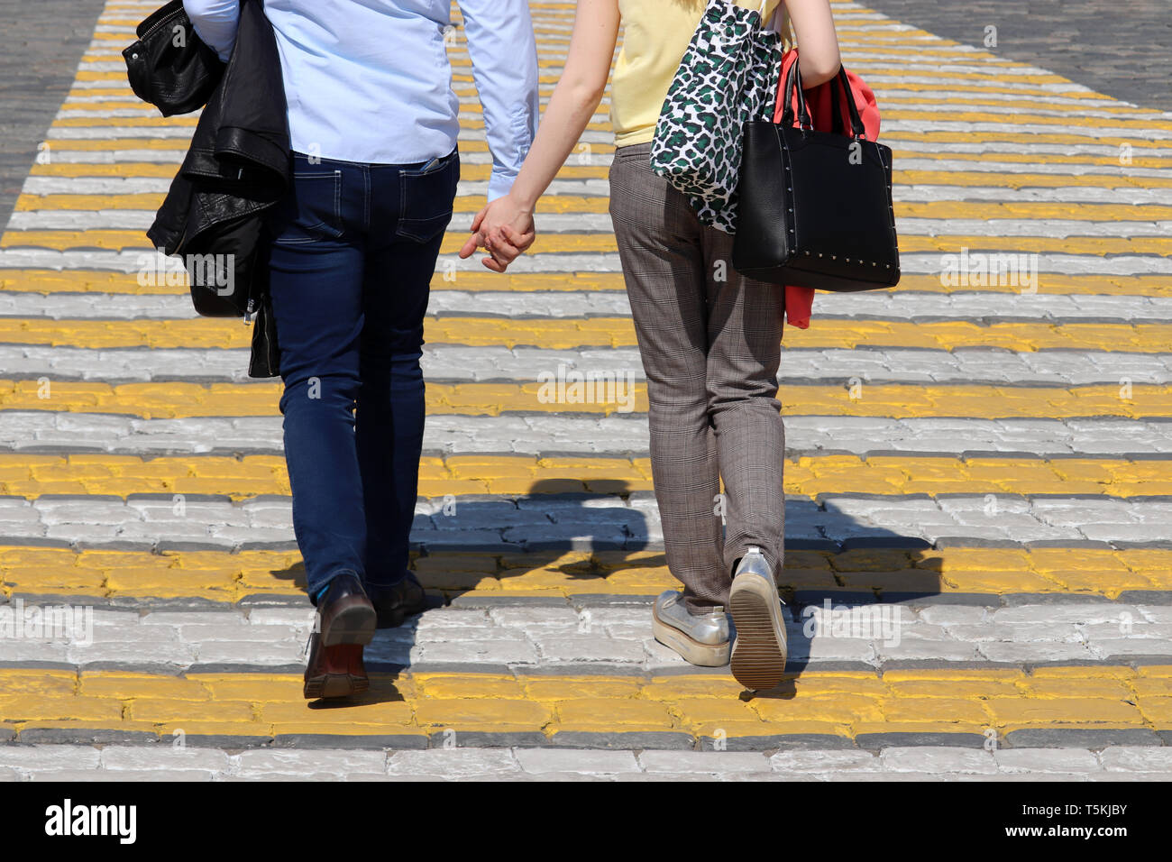 Holding hands crossing road hi-res stock photography and images - Alamy
