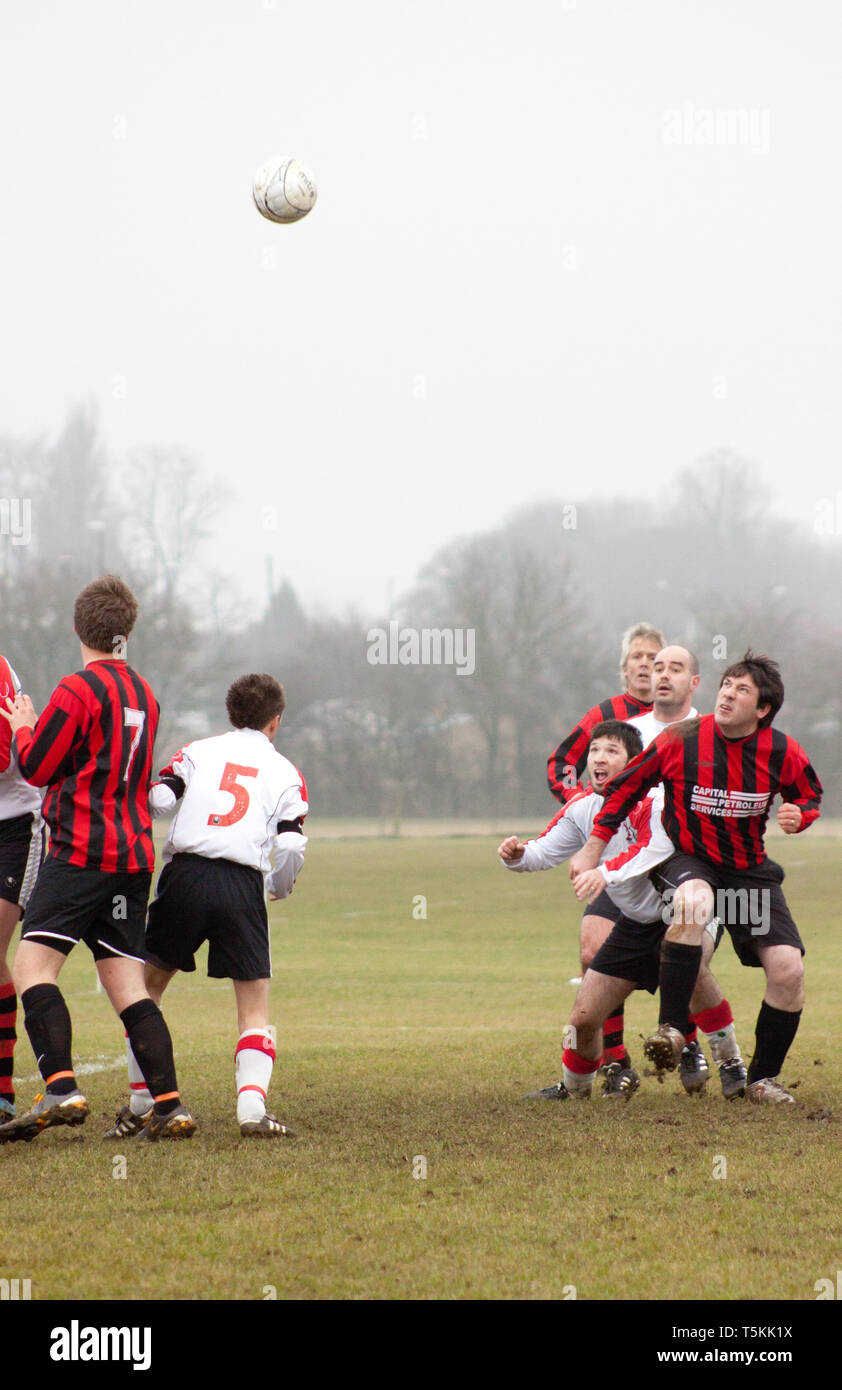 Players watching the ball before headering it Stock Photo - Alamy