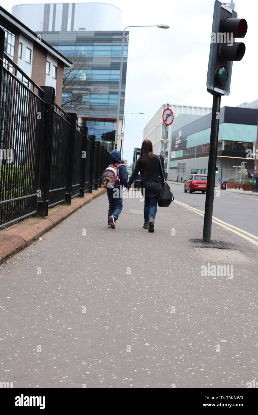 Child walking with parents hi-res stock photography and images - Alamy