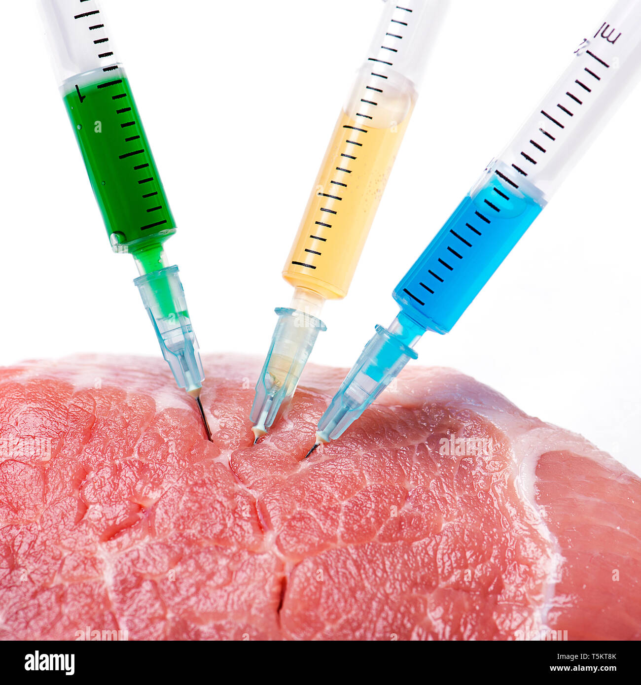 Injection into fresh meat on white background Stock Photo - Alamy
