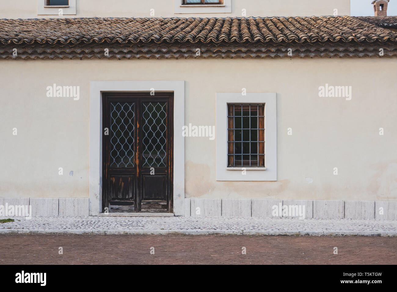 Building exterior front view of wallwith closed door and window, roof ...