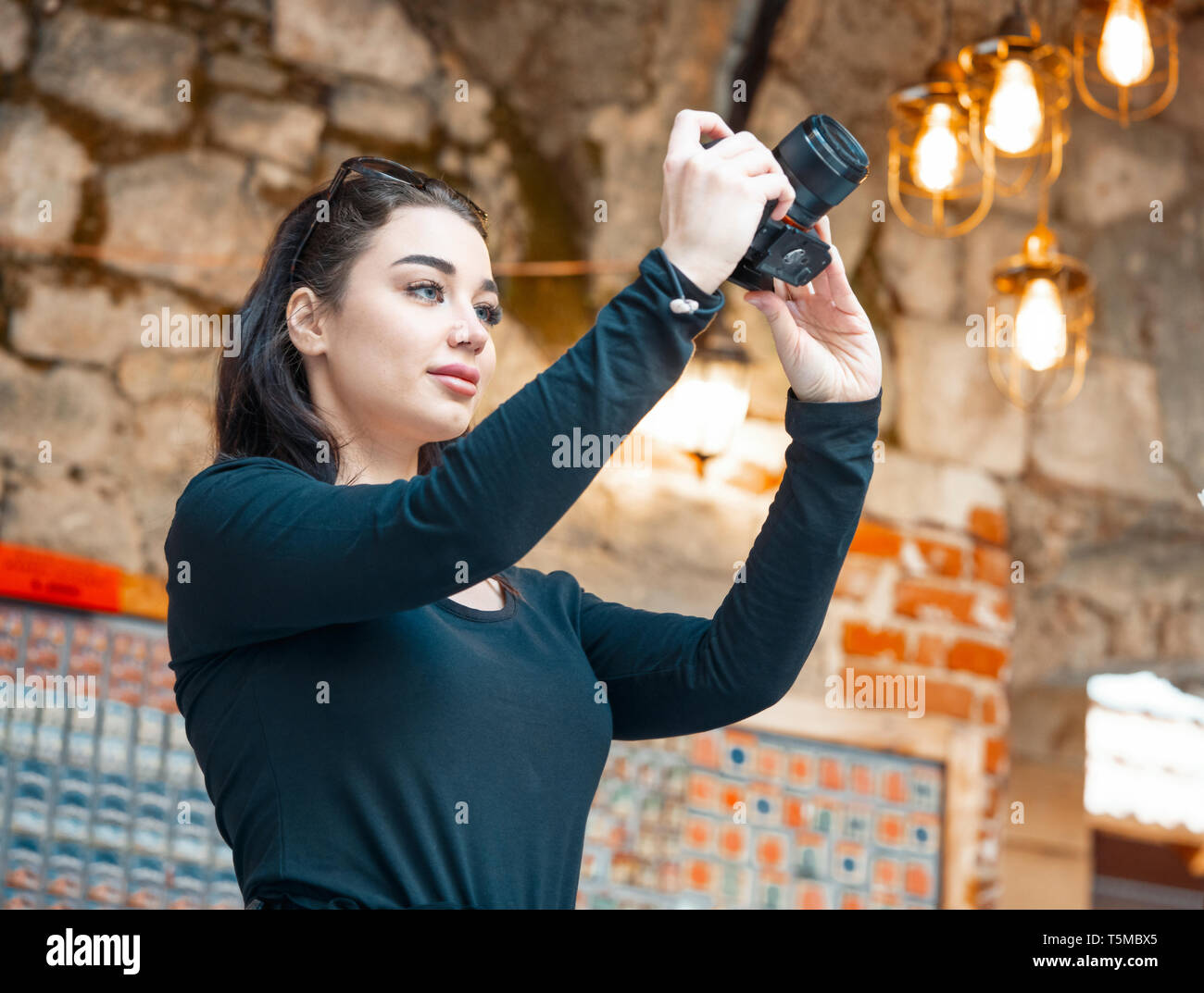 Attractive woman blogger making photos of foreign ancient architecture ...