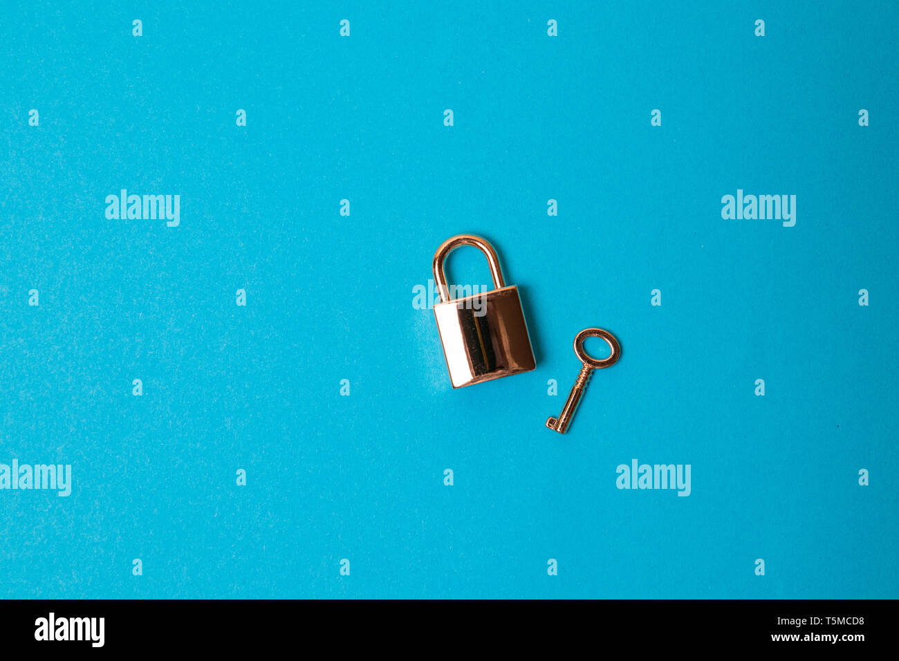 The top view shot of locked padlock with the key on it Stock Photo - Alamy