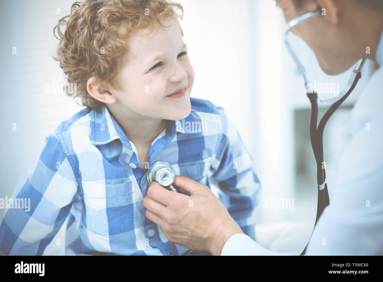 Doctor and patient child. Physician examining little boy. Regular ...