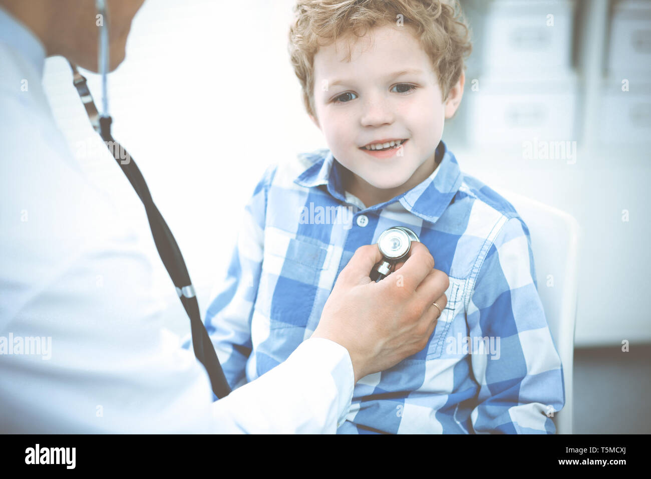 Doctor and patient child. Physician examining little boy. Regular ...