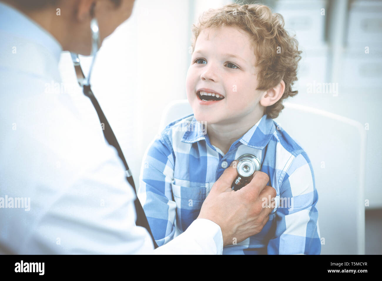 Doctor and patient child. Physician examining little boy. Regular ...