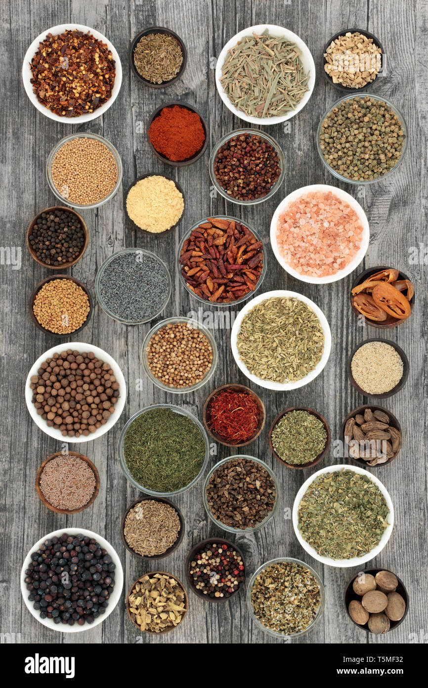 Dried herbs and spices on rustic wood background Stock Photo - Alamy