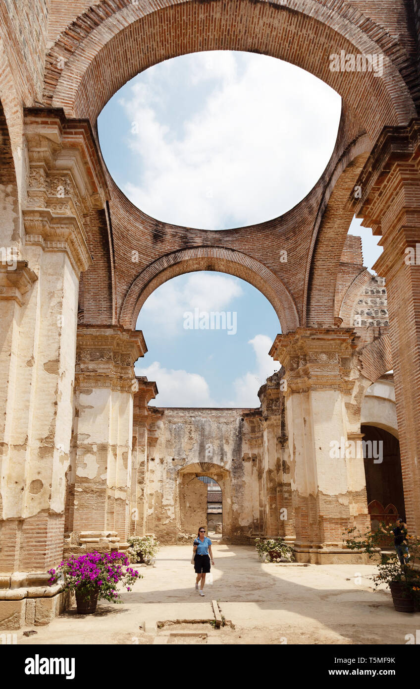 A tourist walking in the ruins of the old cathedral destroyed in the ...