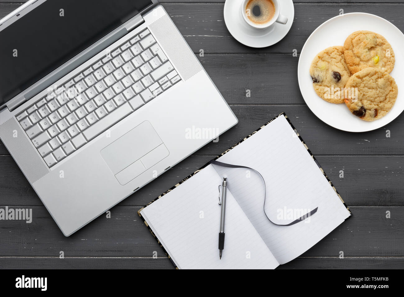 working coffee break with laptop, coffee, cookies and note pad on a ...