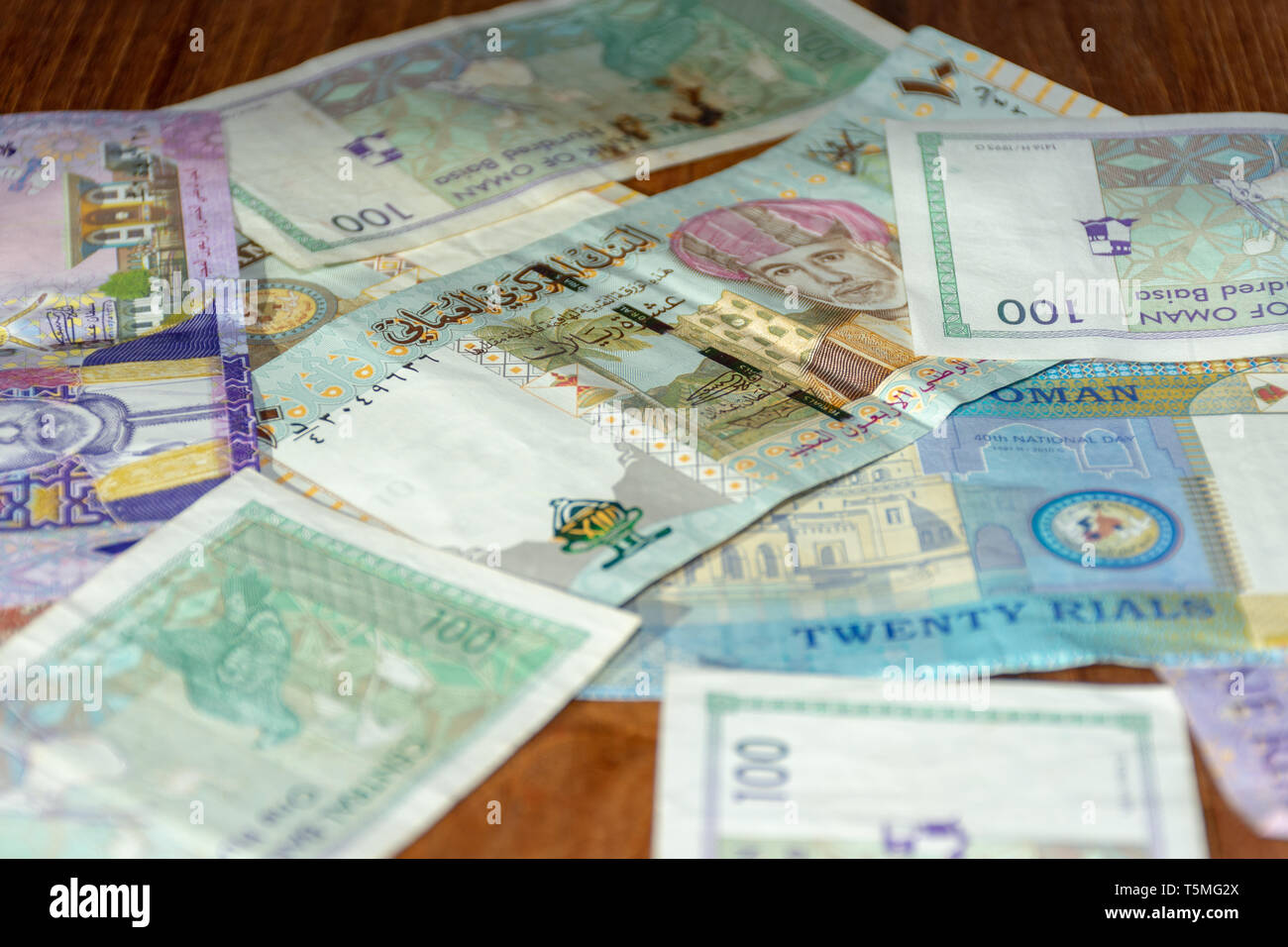 The Riyal Currency of the Oman notes spread out on the table. Money ...