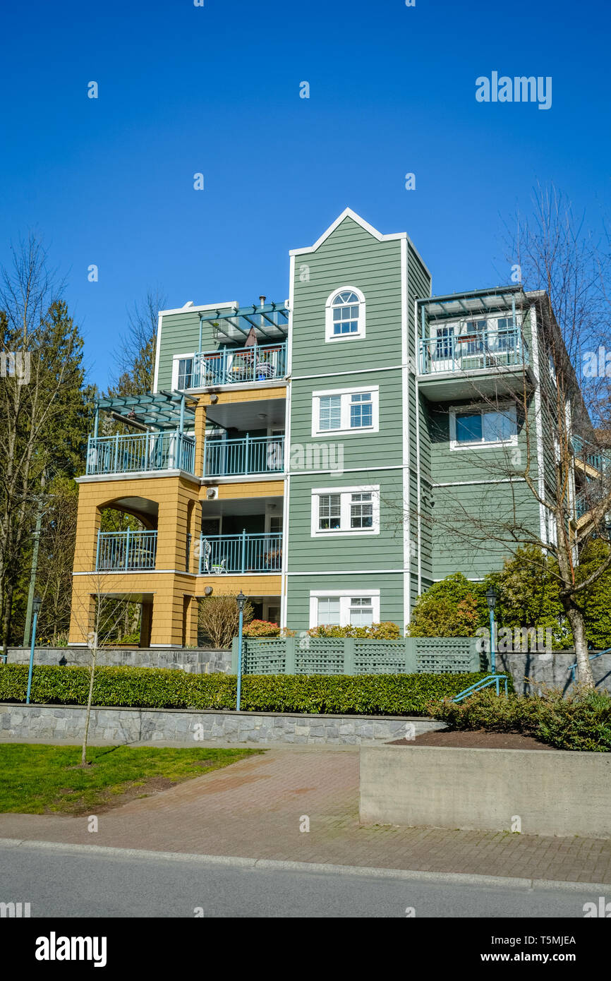 Low rise residential building on blue sky background Stock Photo - Alamy