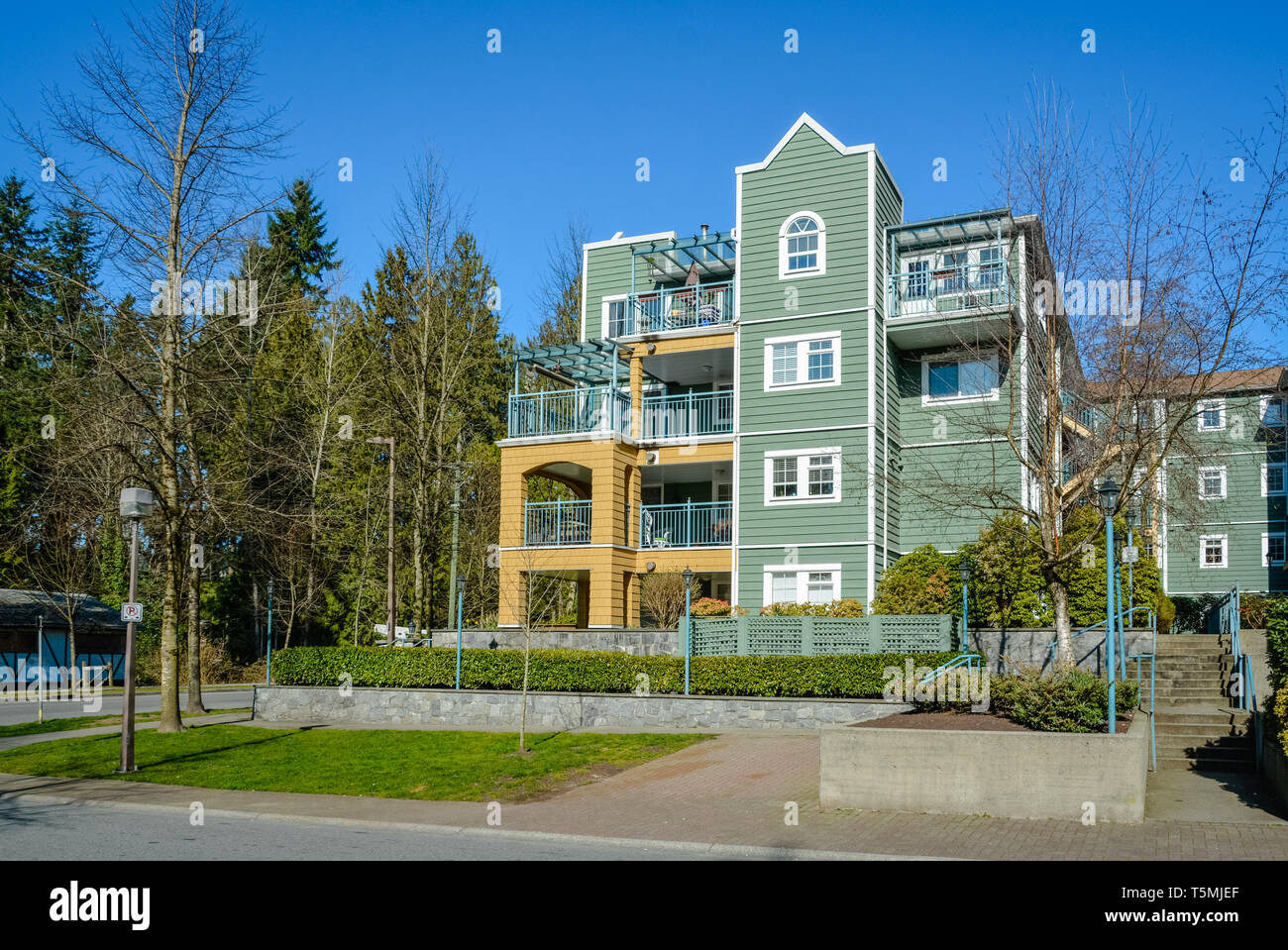 Low rise residential building on a street with blue sky background ...