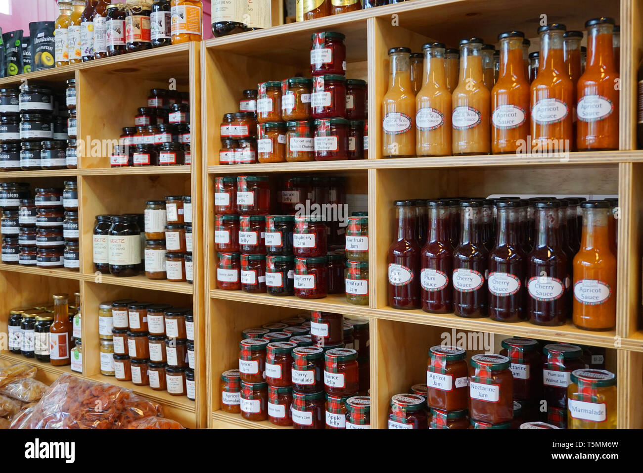 Cromwell/ New Zealand:Jam fruit jar on wooden shelf strawberry apricot ...