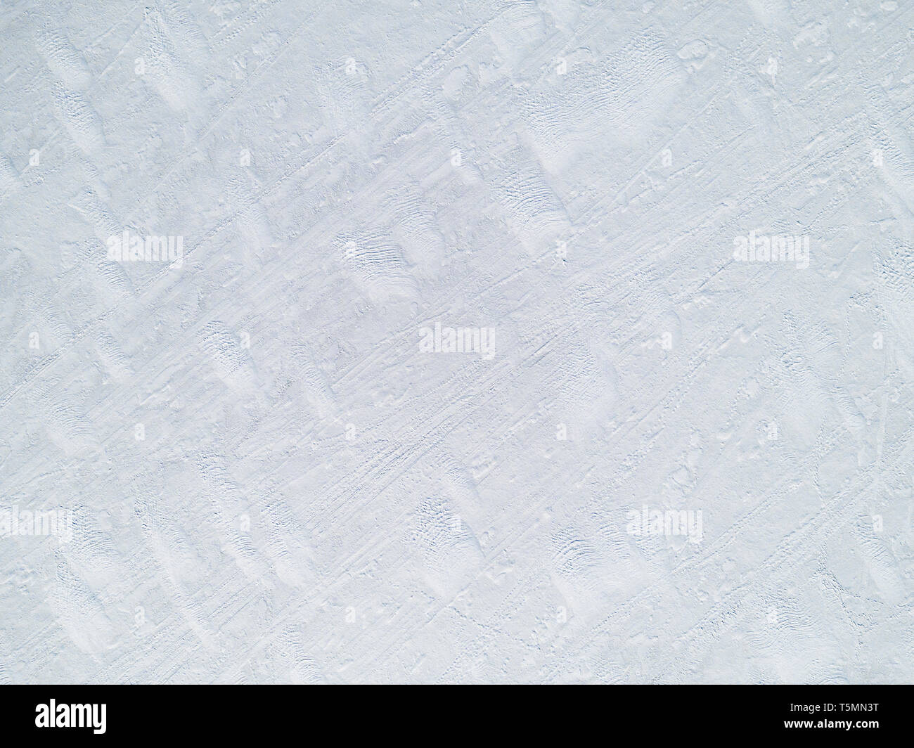 Aerial view of a frozen lake surface. Aerial Snow pattern on the frozen ...