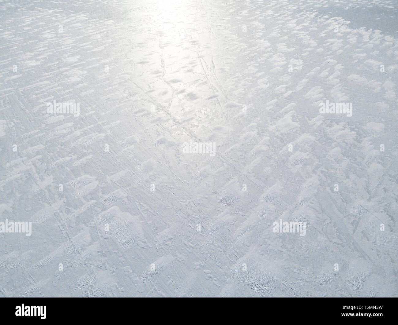 Aerial view of a frozen lake surface. Aerial Snow pattern on the frozen ...