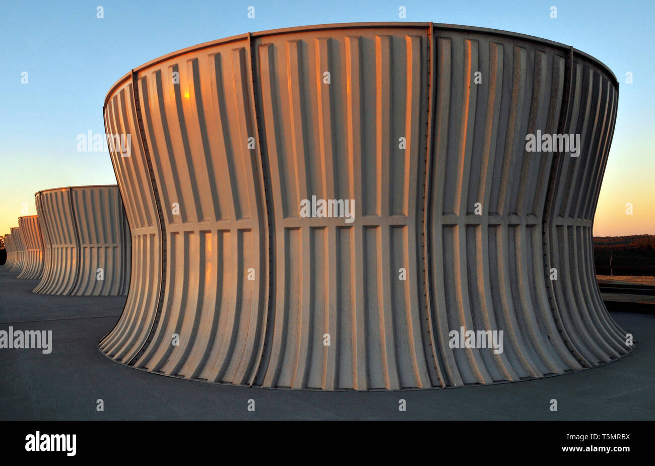 A sunset view of circular cooling towers at a coal mine Stock Photo - Alamy