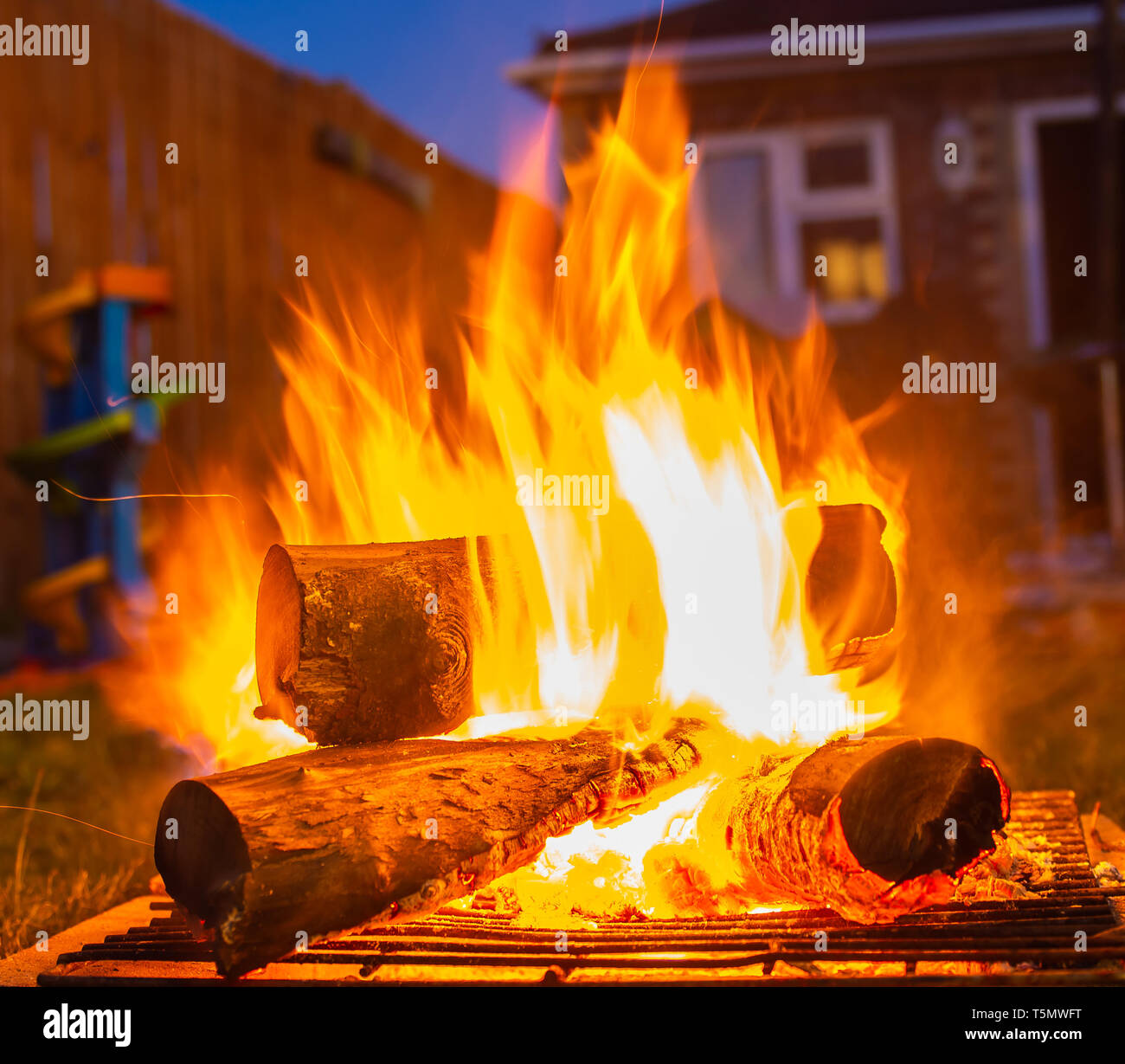 Camp site Fire in safe place on the grass Stock Photo - Alamy