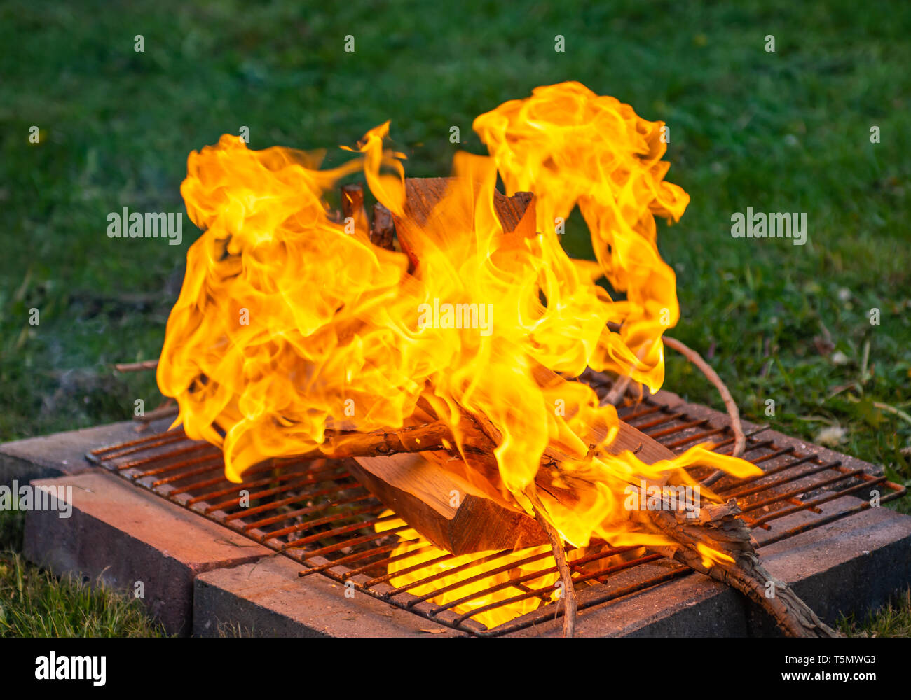 Camp site Fire in safe place on the grass Stock Photo - Alamy