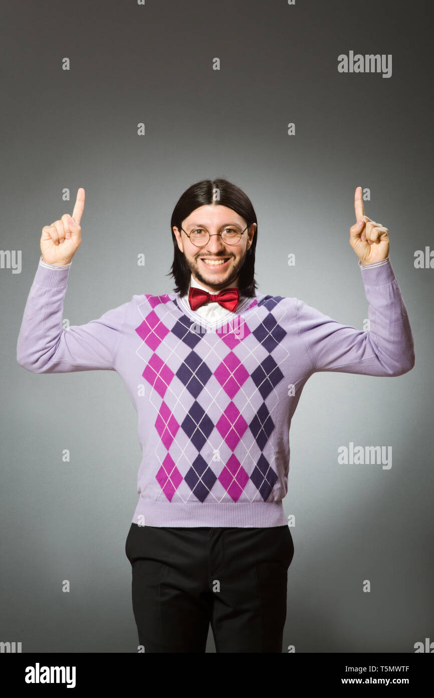Young man wearing pullover on grey background Stock Photo - Alamy