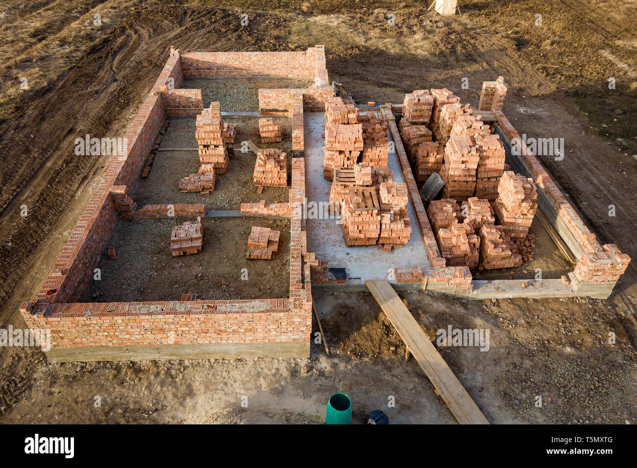 Aerial view of building site. Trenches dug in ground and filled with ...
