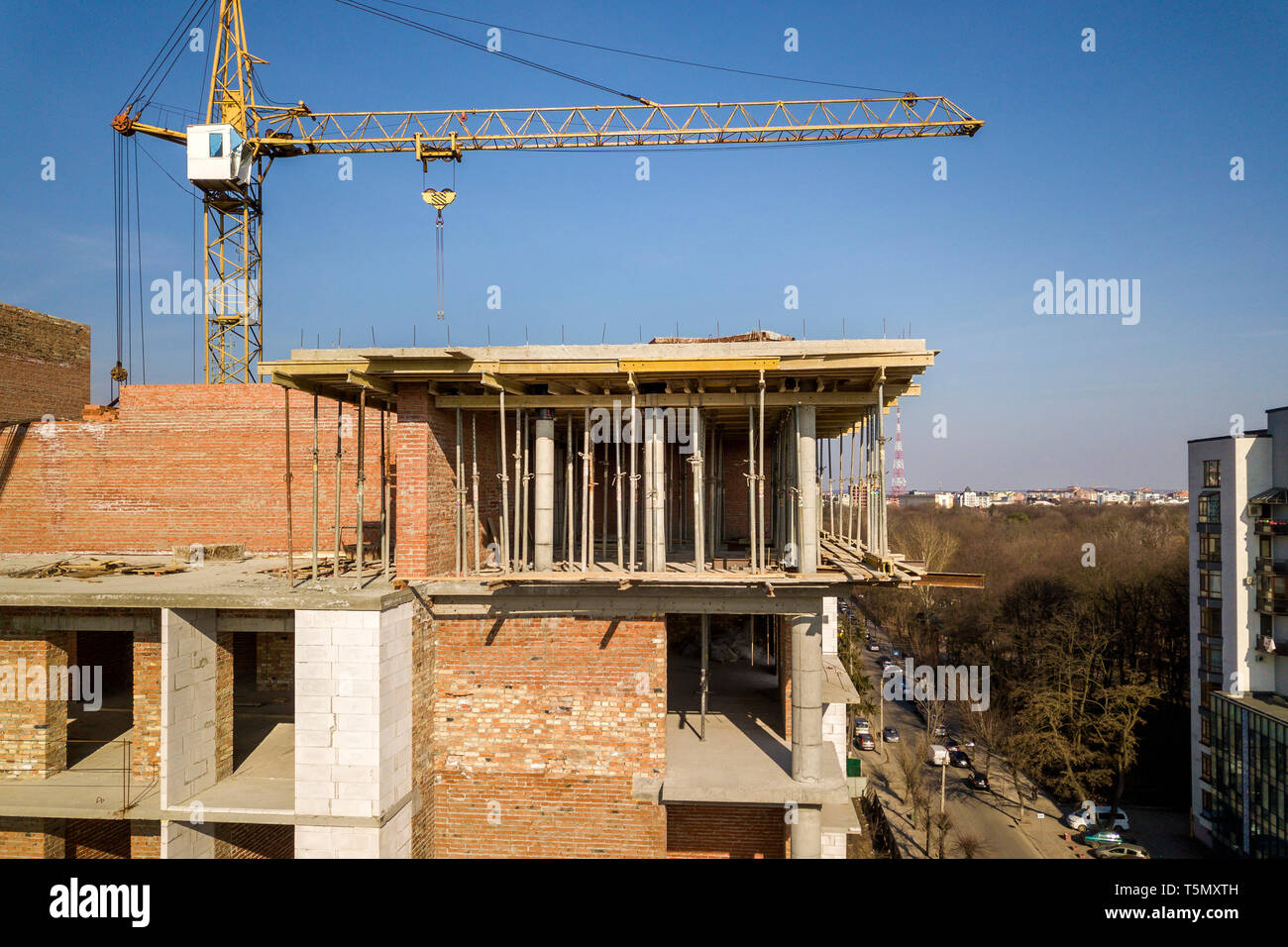 Apartment or office tall building under construction, top view. Brick ...