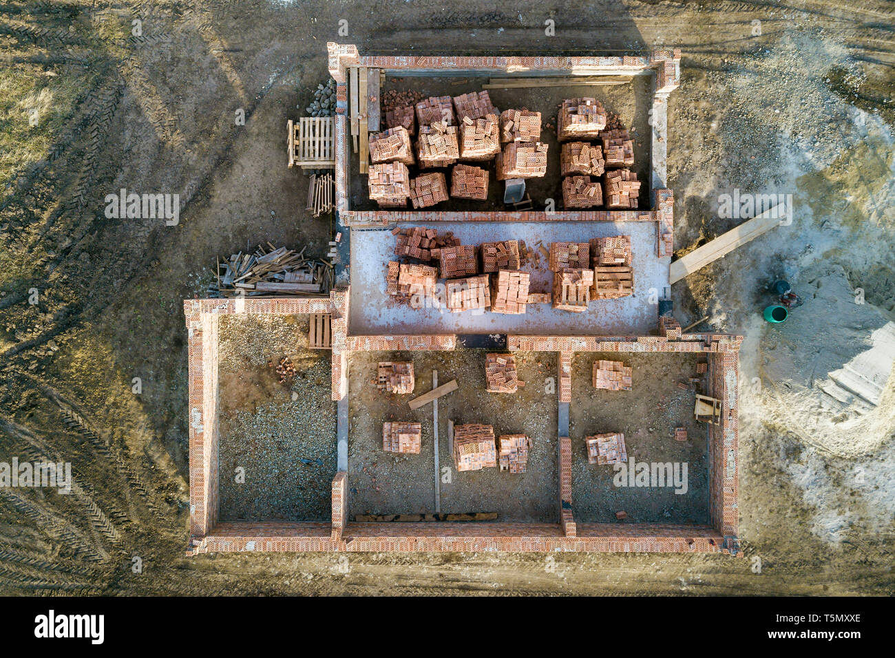 Aerial view of building site. Trenches dug in ground and filled with ...