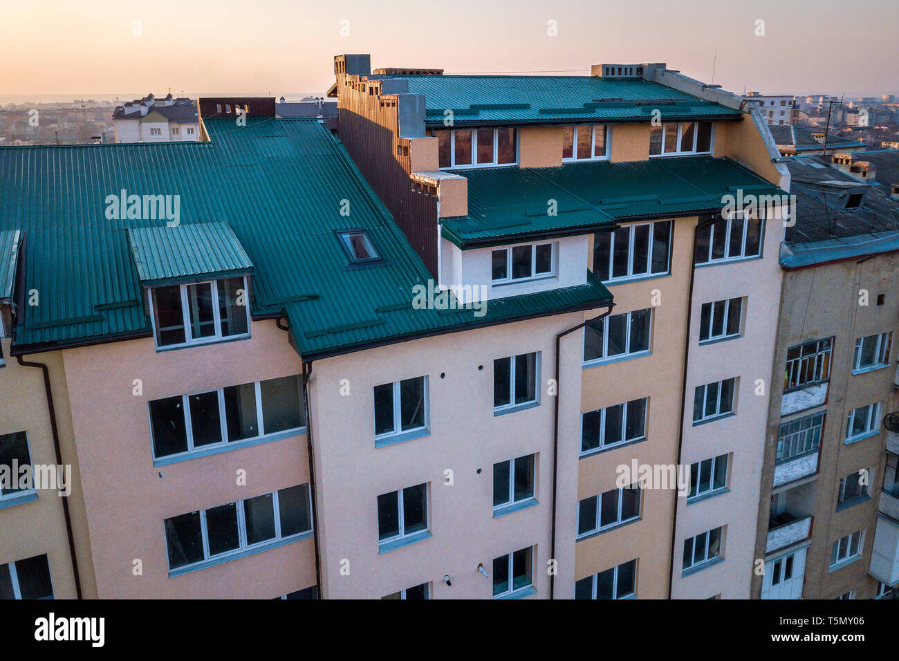 Aerial view of attic annex room exterior with plastic windows, roof and ...