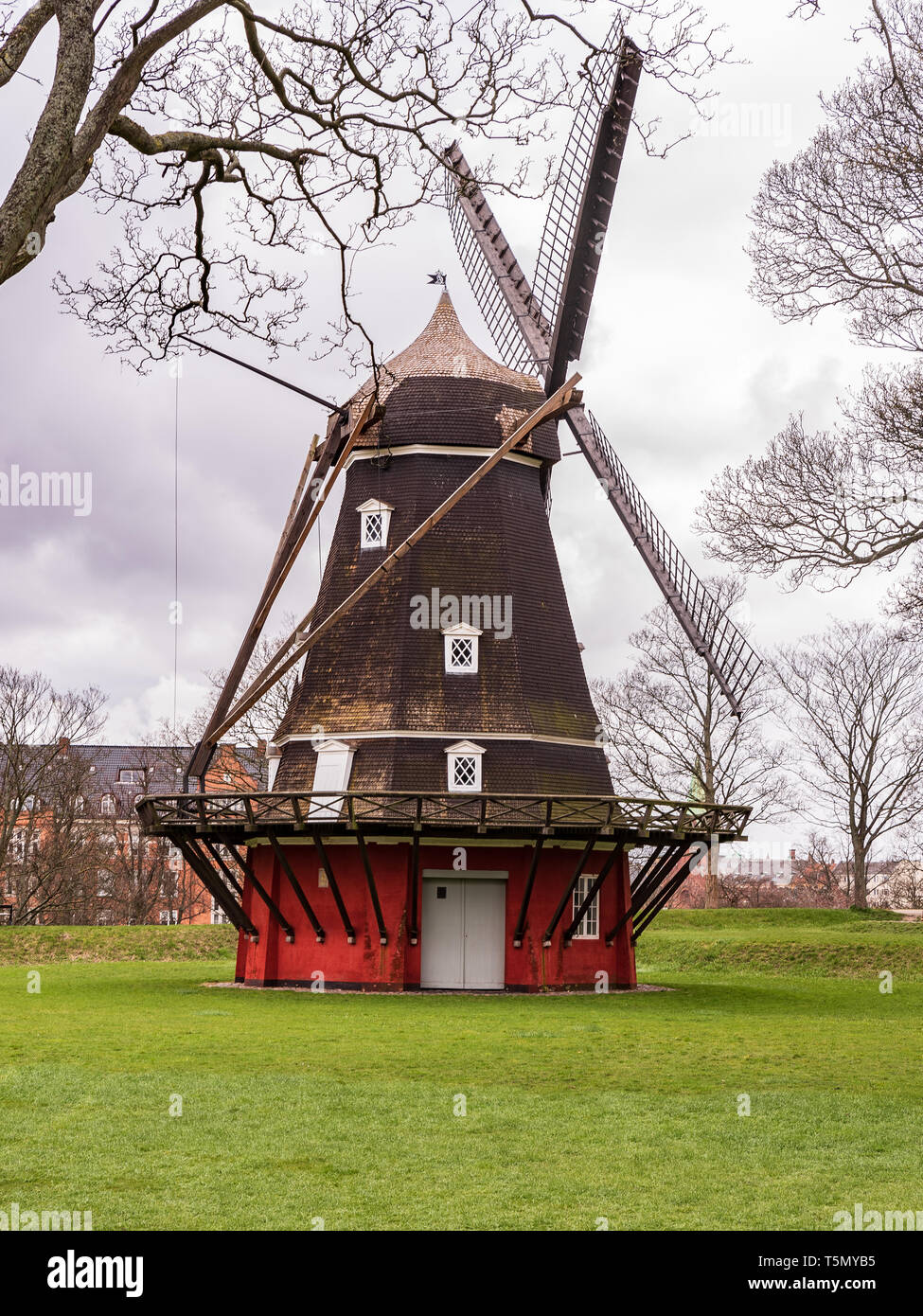Ancient windmill from the main wooden structure and the base of red ...