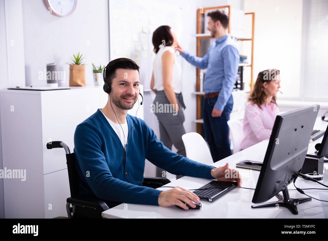 Man sitting desk in wheelchair hi-res stock photography and images - Alamy