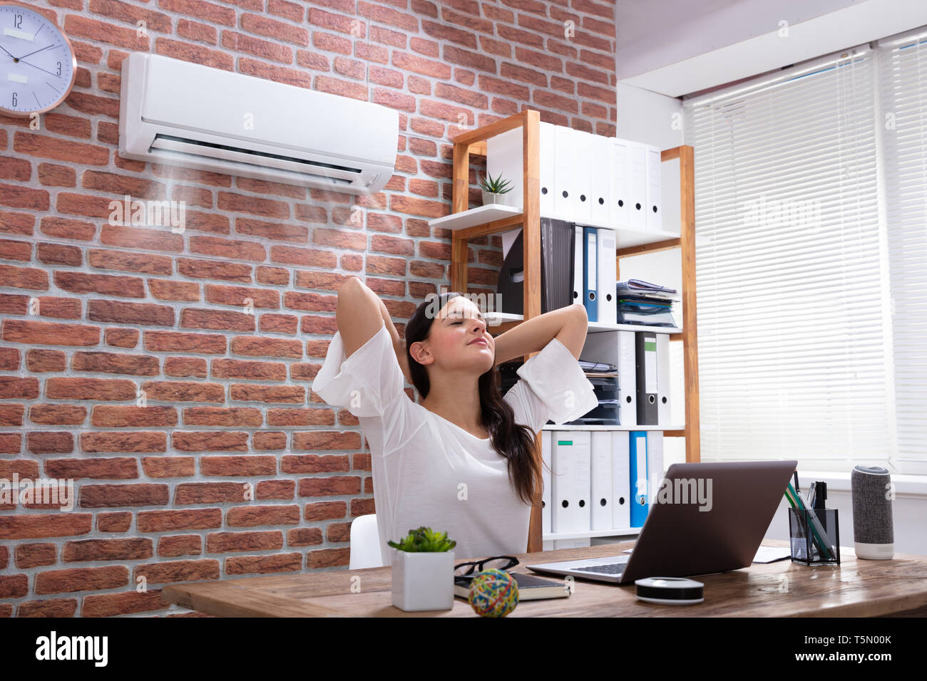 Relaxed Businesswoman Enjoying The Cooling Of Air Conditioner In The ...