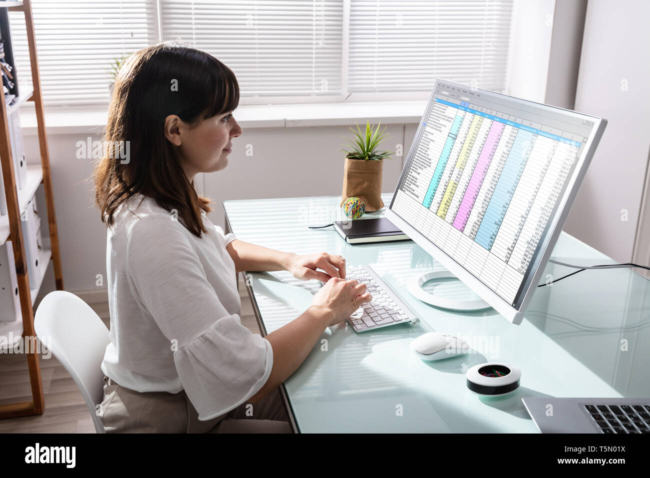 Businesswoman analyzing business data spreadsheet hi-res stock ...