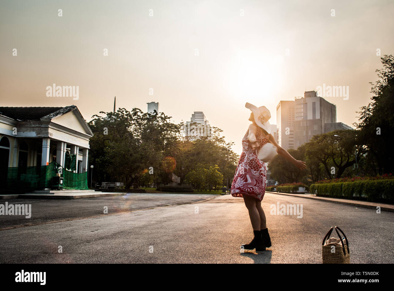 Young woman relaxing in summer sunset sky outdoor. People freedom style ...