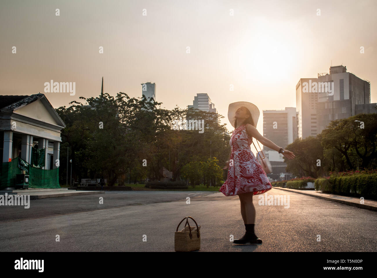 Young woman relaxing in summer sunset sky outdoor. People freedom style ...