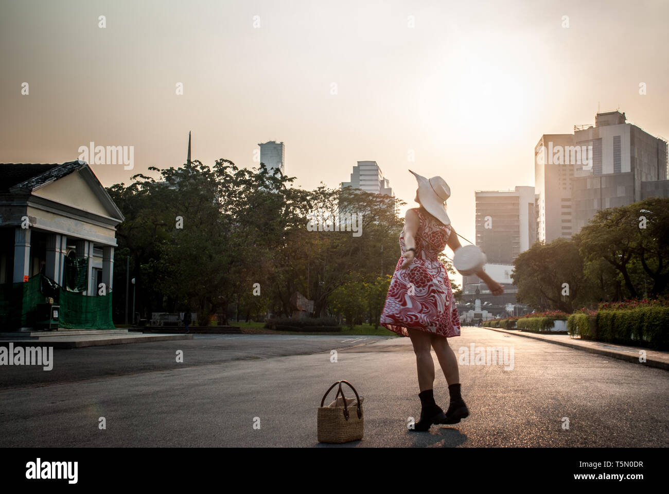 Young woman relaxing in summer sunset sky outdoor. People freedom style ...