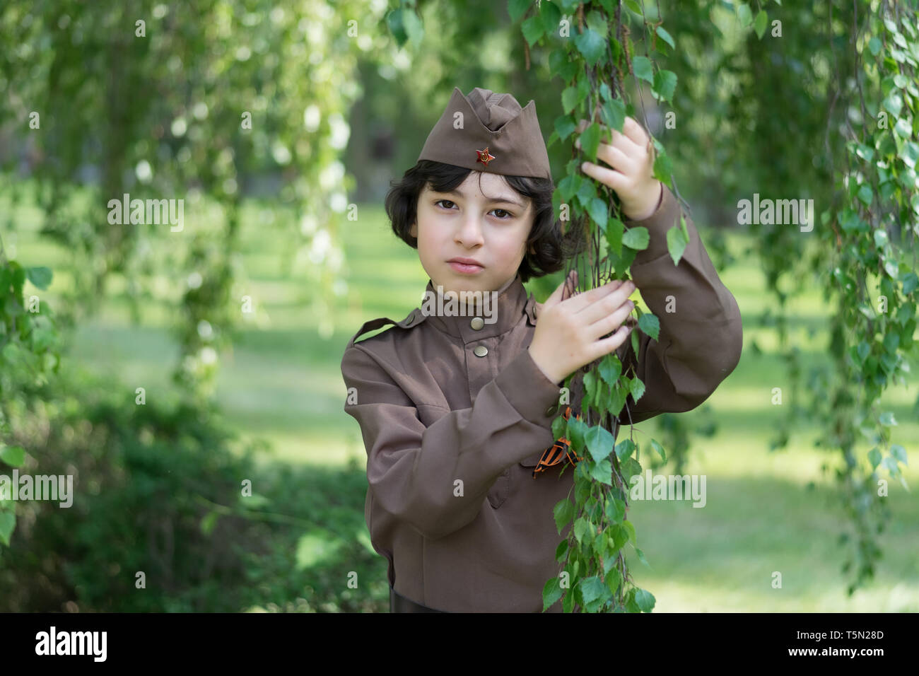 Portrait of a boy in the uniform of a soldier of the Red Army during ...