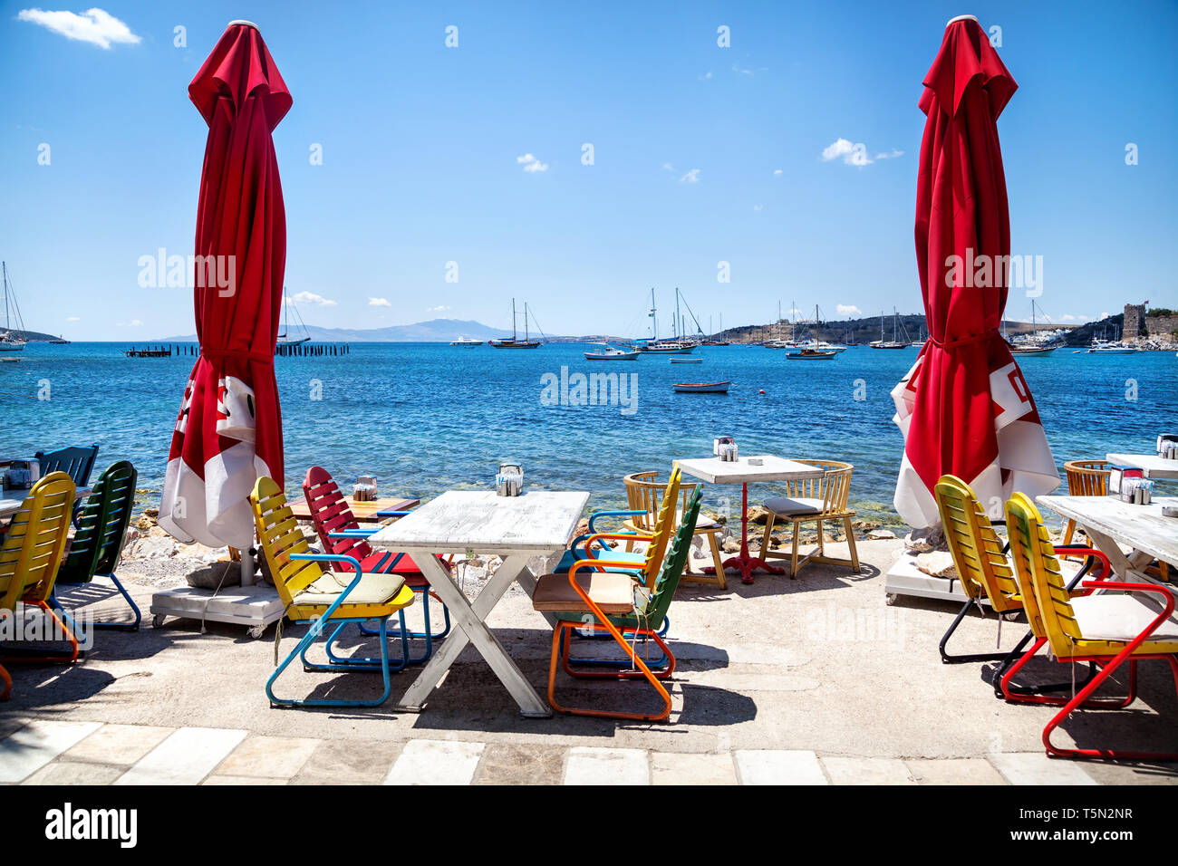 Colorful chairs and white table in seaside restaurant in Bodrum, Turkey ...