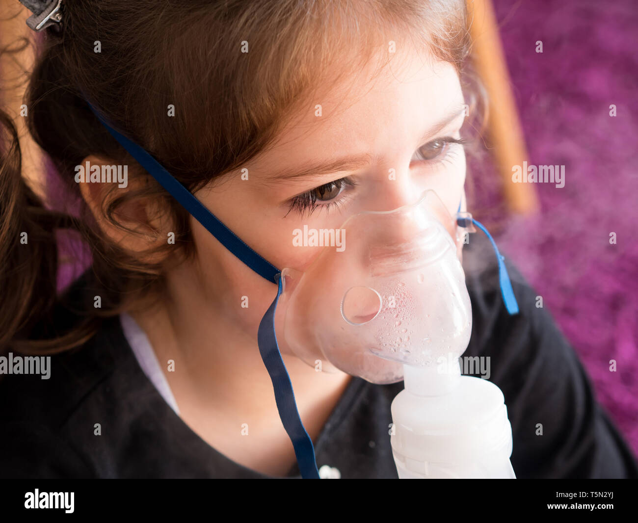 Cute caucasian girl face with oxygen mask close up Stock Photo - Alamy