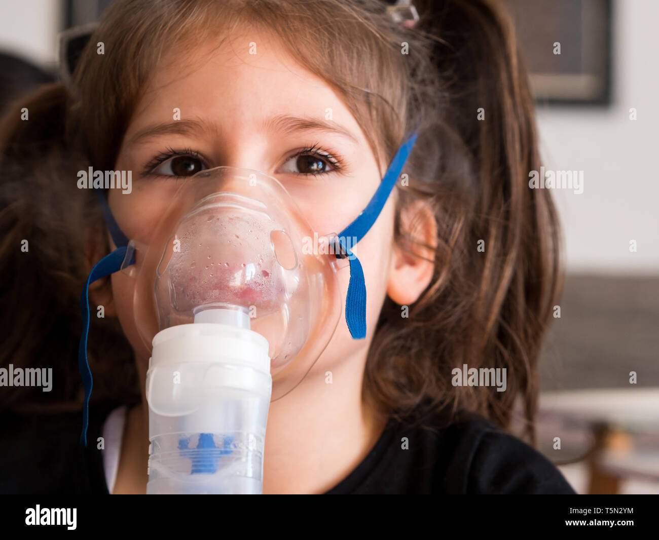 Cute little girl making inhalation with inhaler close up Stock Photo ...