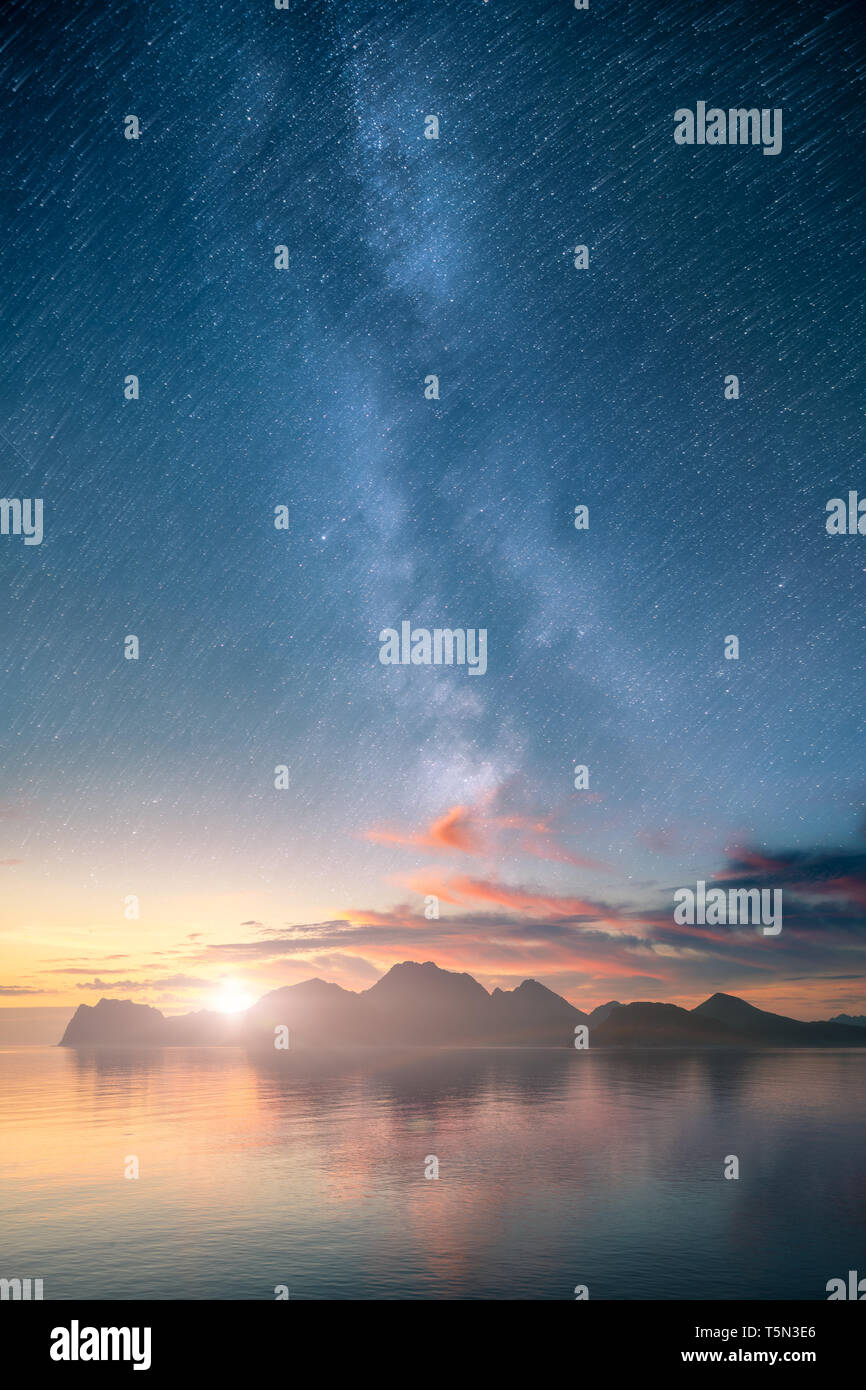 Beautiful vertical view of an ocean and mountains with epic milky way ...